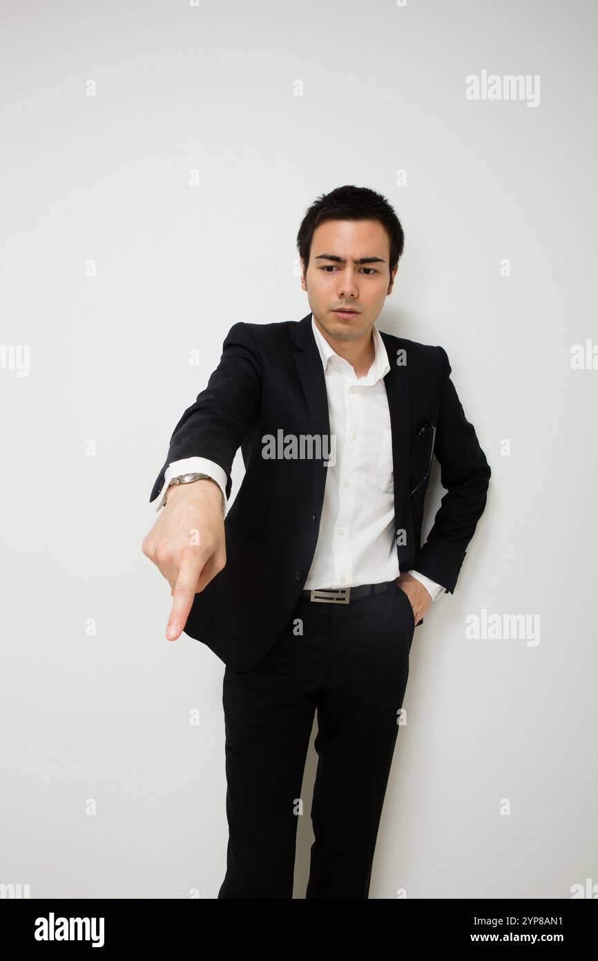 Businessman pointing finger Stock Photo - Alamy