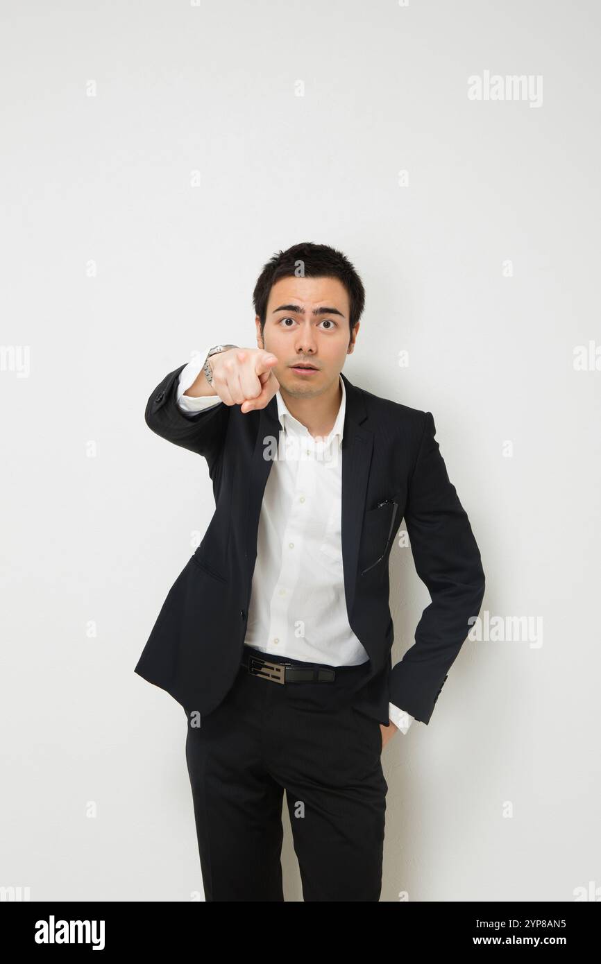 Businessman pointing finger Stock Photo - Alamy