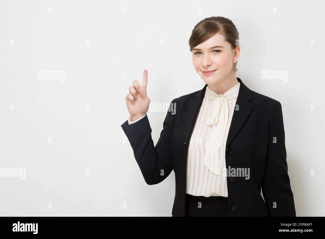 Businesswoman holding up index finger Stock Photo - Alamy