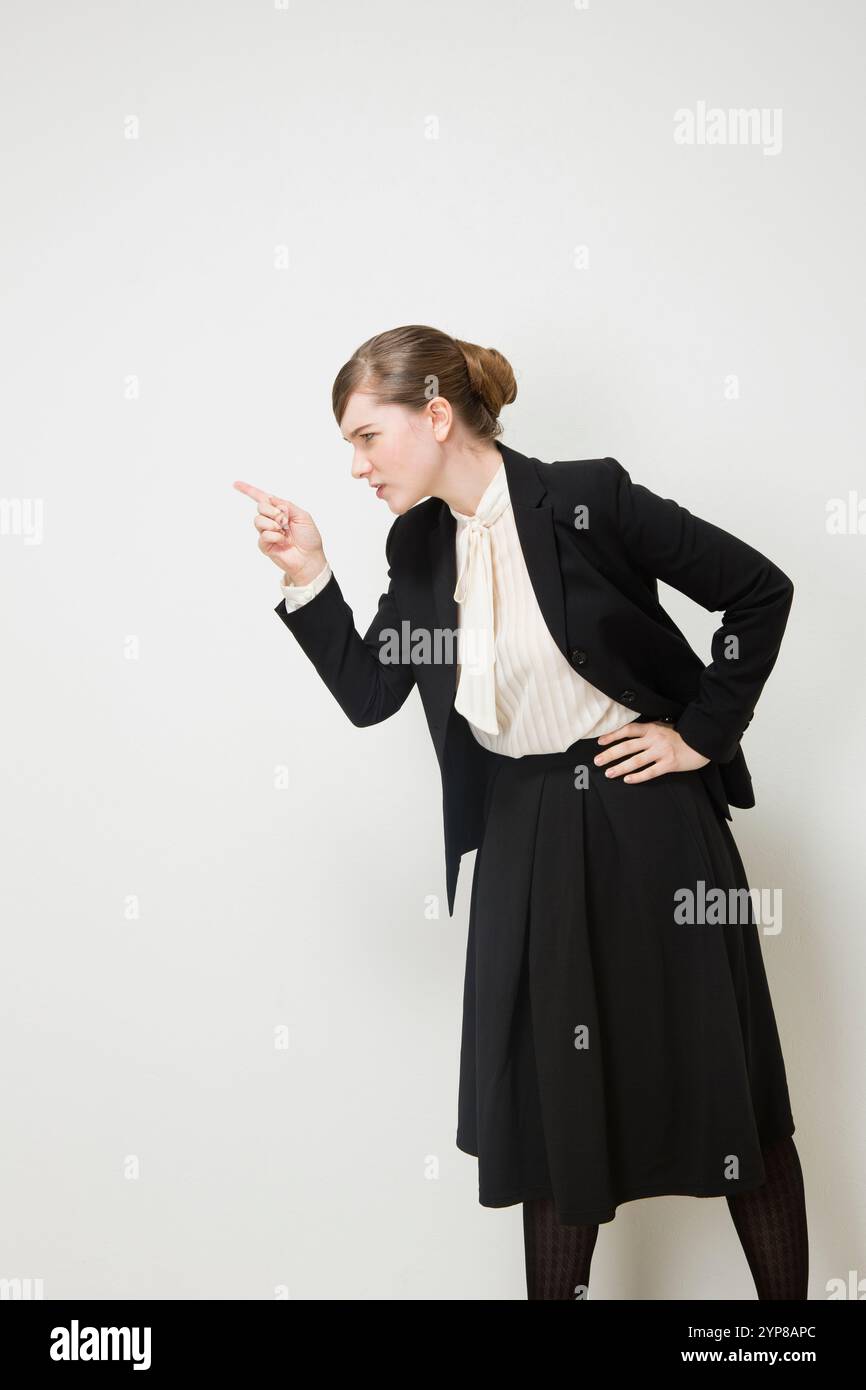 Businesswoman giving a stern warning Stock Photo - Alamy