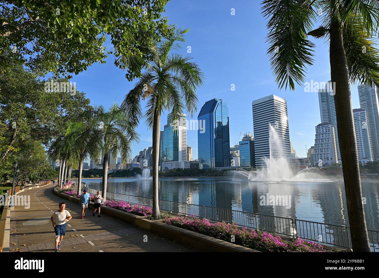 People exercising along Lake Ratchada, with commercial and residential ...