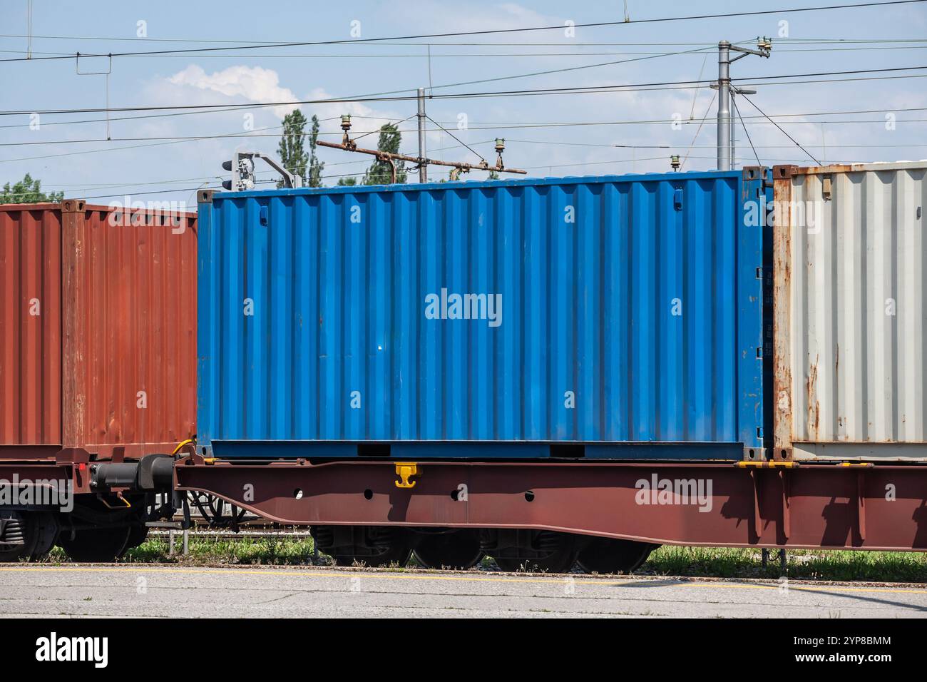 A blue shipping container loaded on a train, illustrating intermodal ...