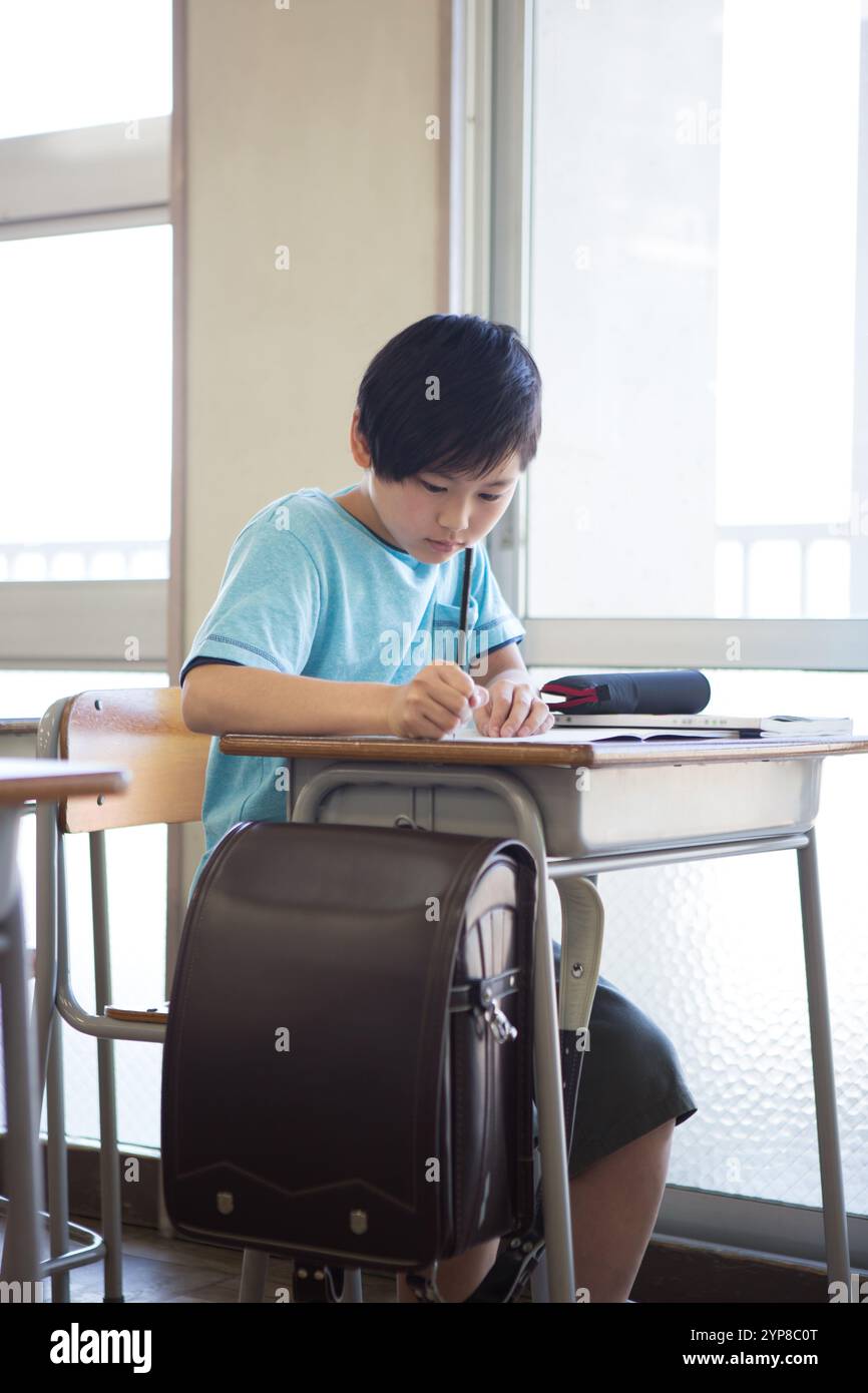 Boys studying in the classroom Stock Photo - Alamy