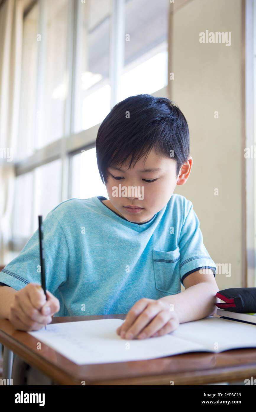 Boys studying in the classroom Stock Photo - Alamy