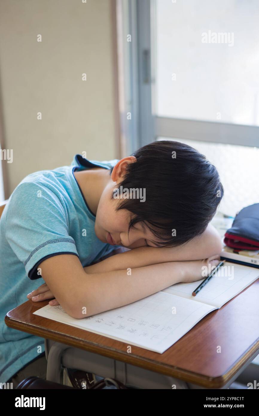 Boy dozing off Stock Photo - Alamy