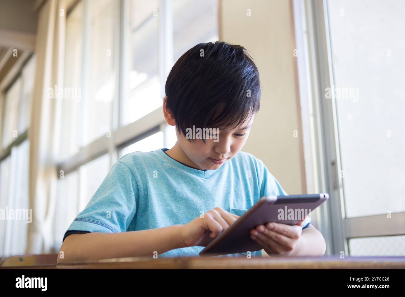 Boy using tablet Stock Photo - Alamy