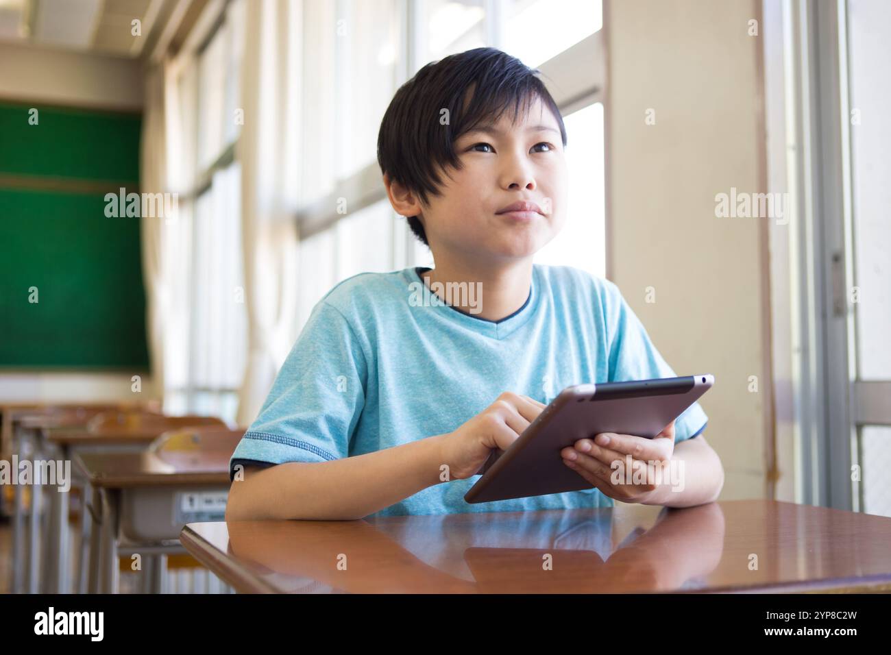 Boy using tablet Stock Photo - Alamy