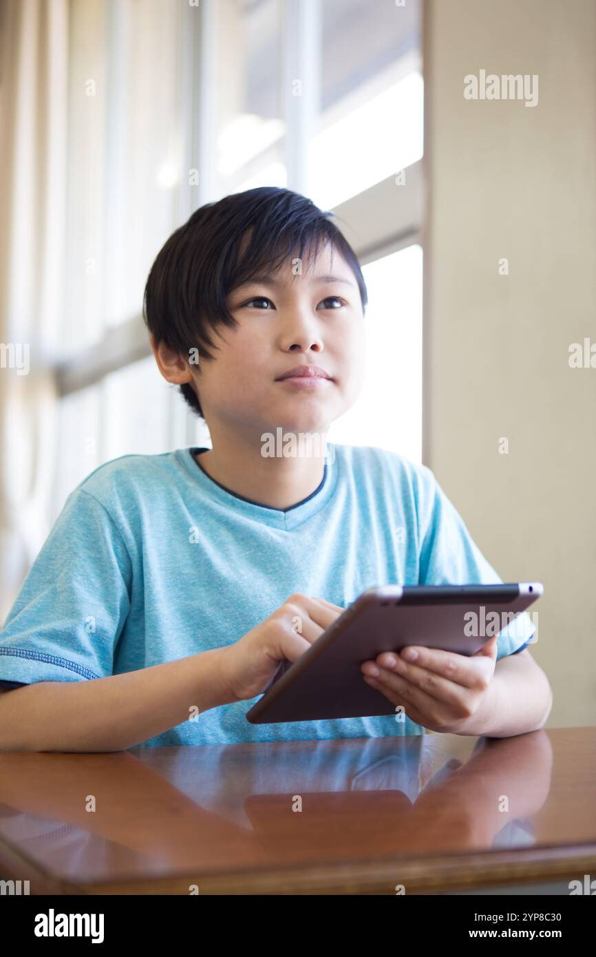 Boy using tablet Stock Photo - Alamy