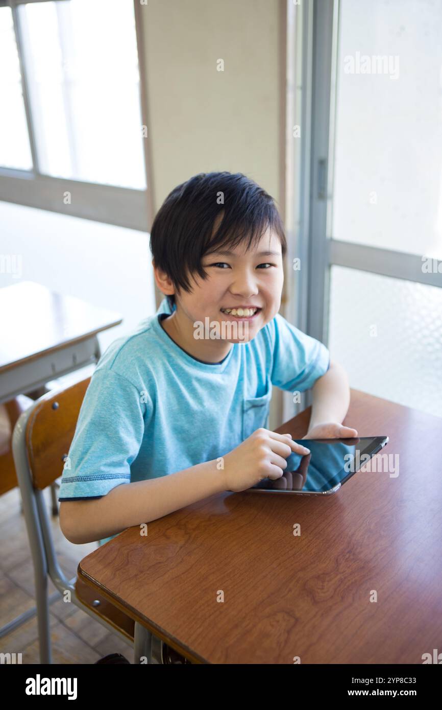 Boy using tablet Stock Photo - Alamy