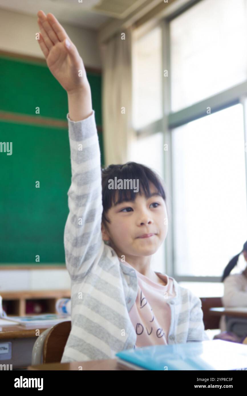 Primary schools students studying in a classroom Stock Photo - Alamy