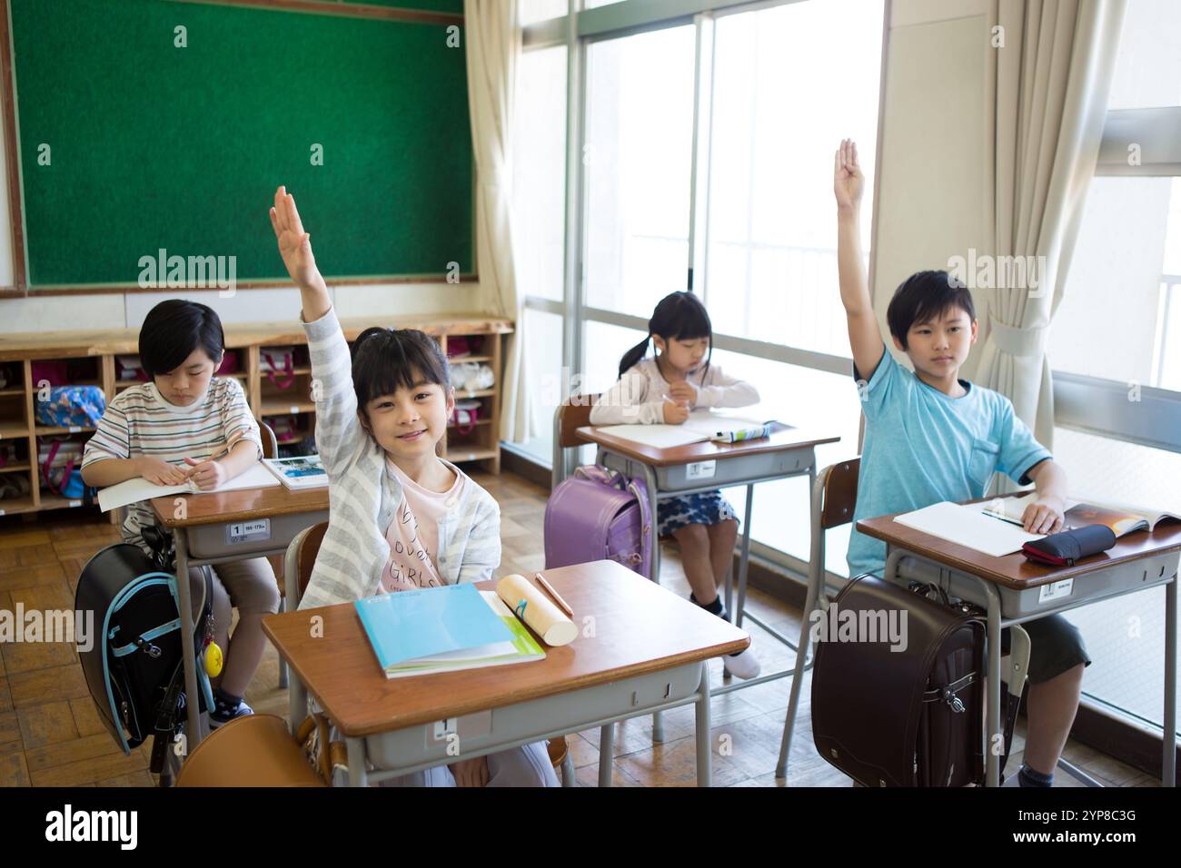 Primary schools students studying in a classroom Stock Photo - Alamy