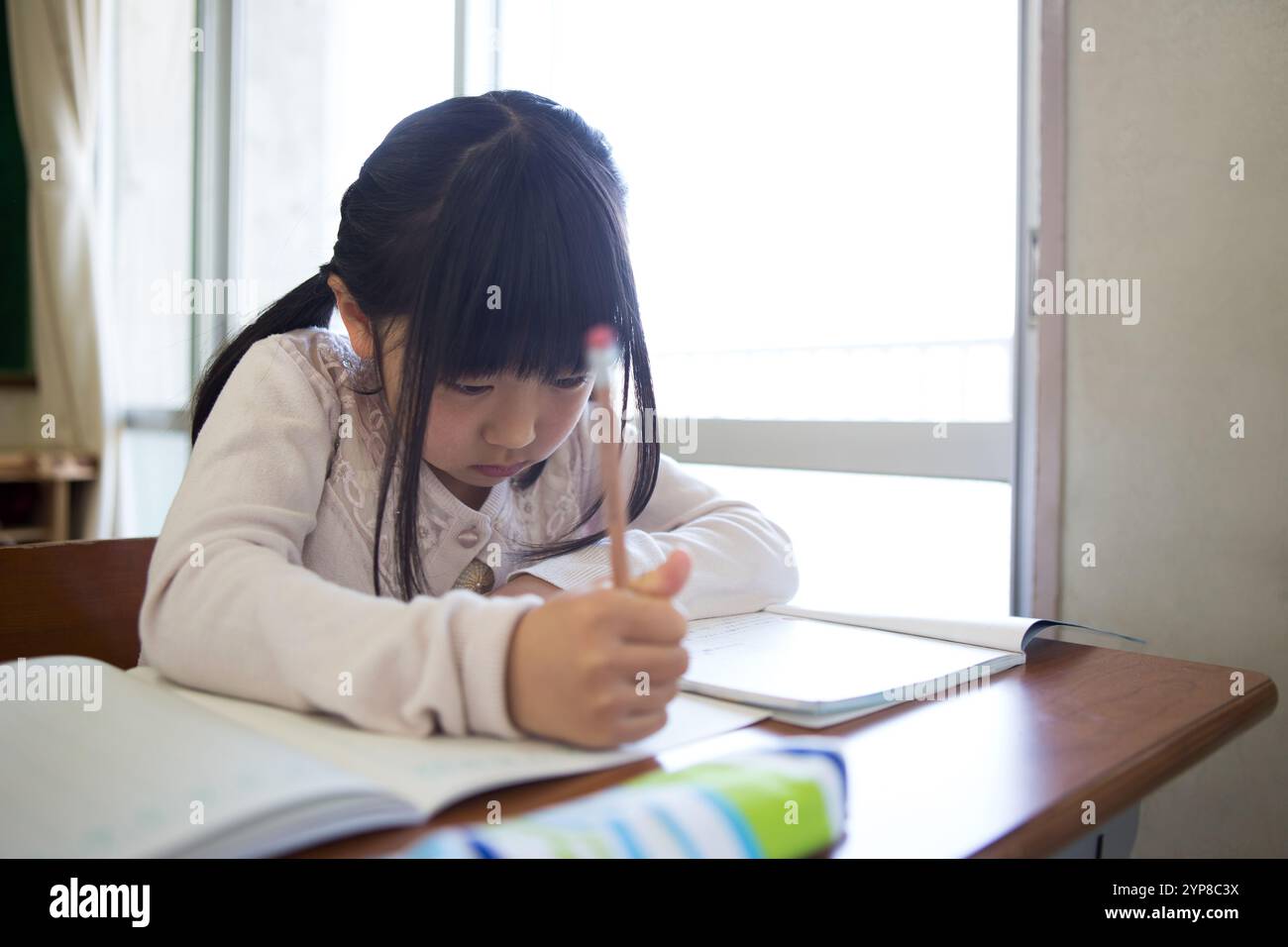 Primary schools students studying in a classroom Stock Photo - Alamy