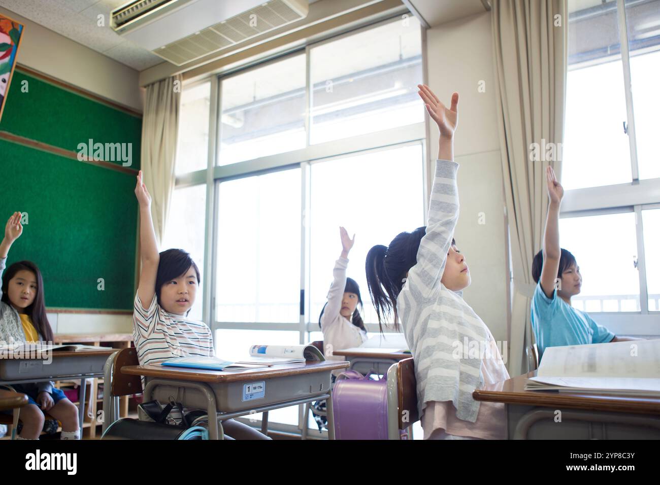 Primary schools students studying in a classroom Stock Photo - Alamy