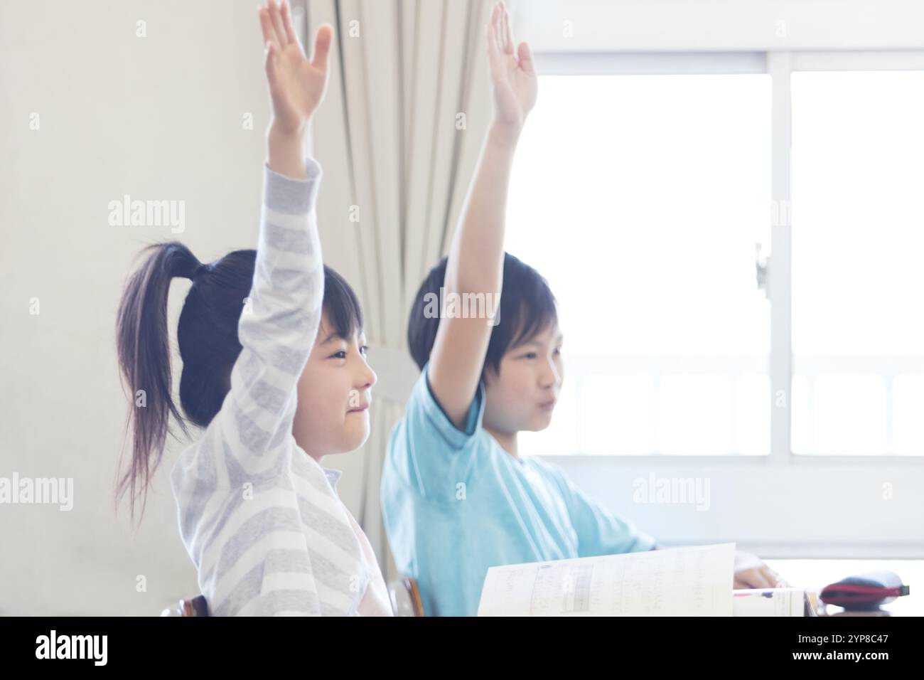 Primary schools students studying in a classroom Stock Photo - Alamy
