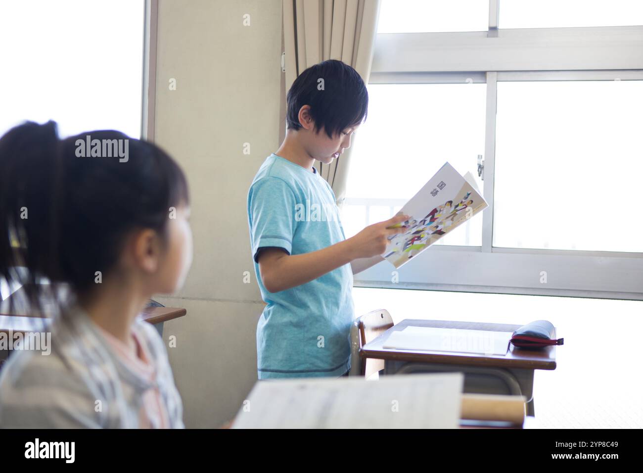 Primary schools students studying in a classroom Stock Photo - Alamy