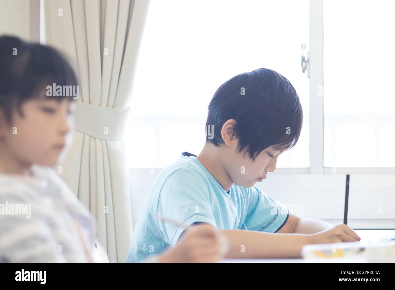 Primary schools students studying in a classroom Stock Photo - Alamy