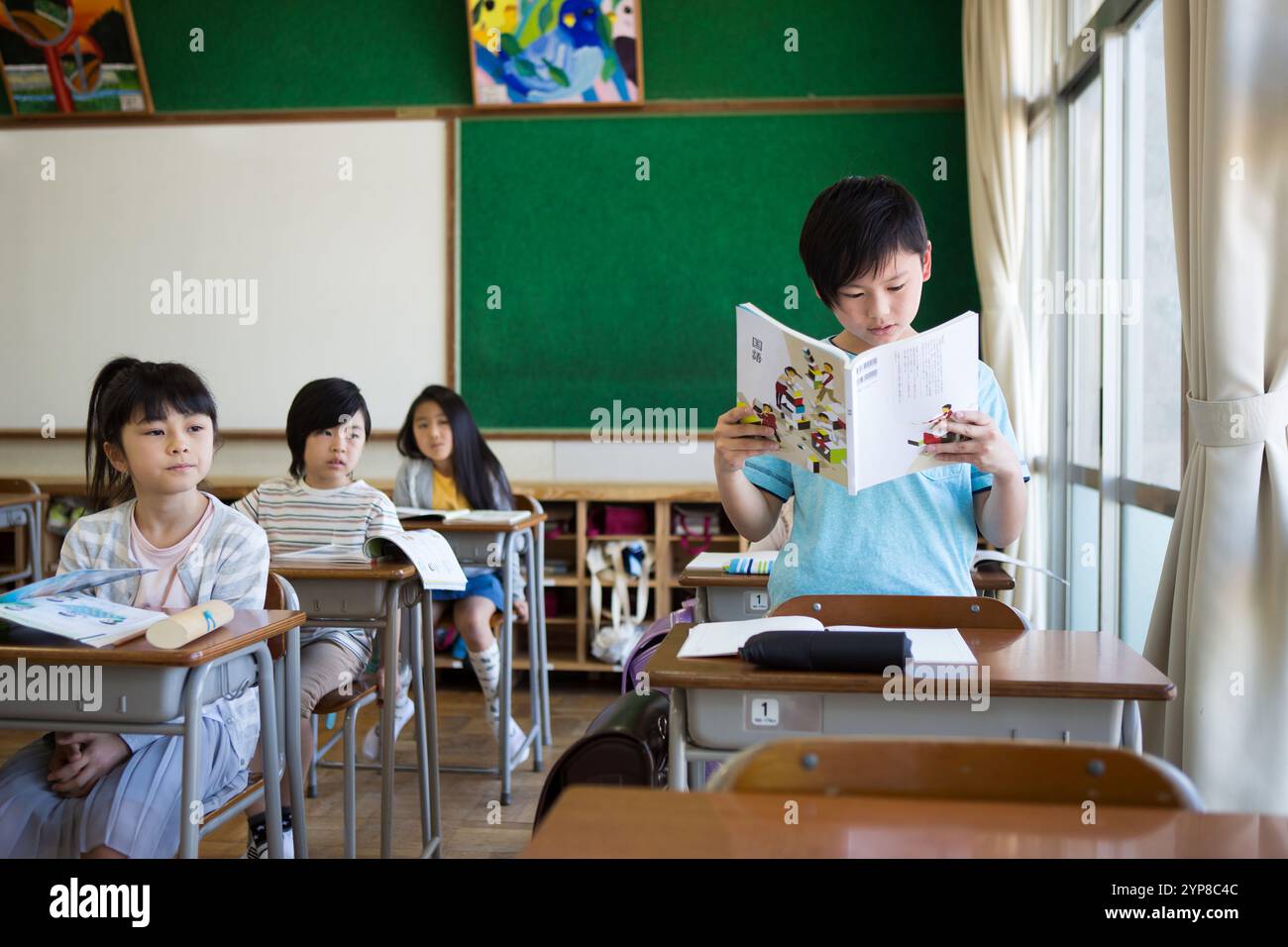Primary schools students studying in a classroom Stock Photo - Alamy