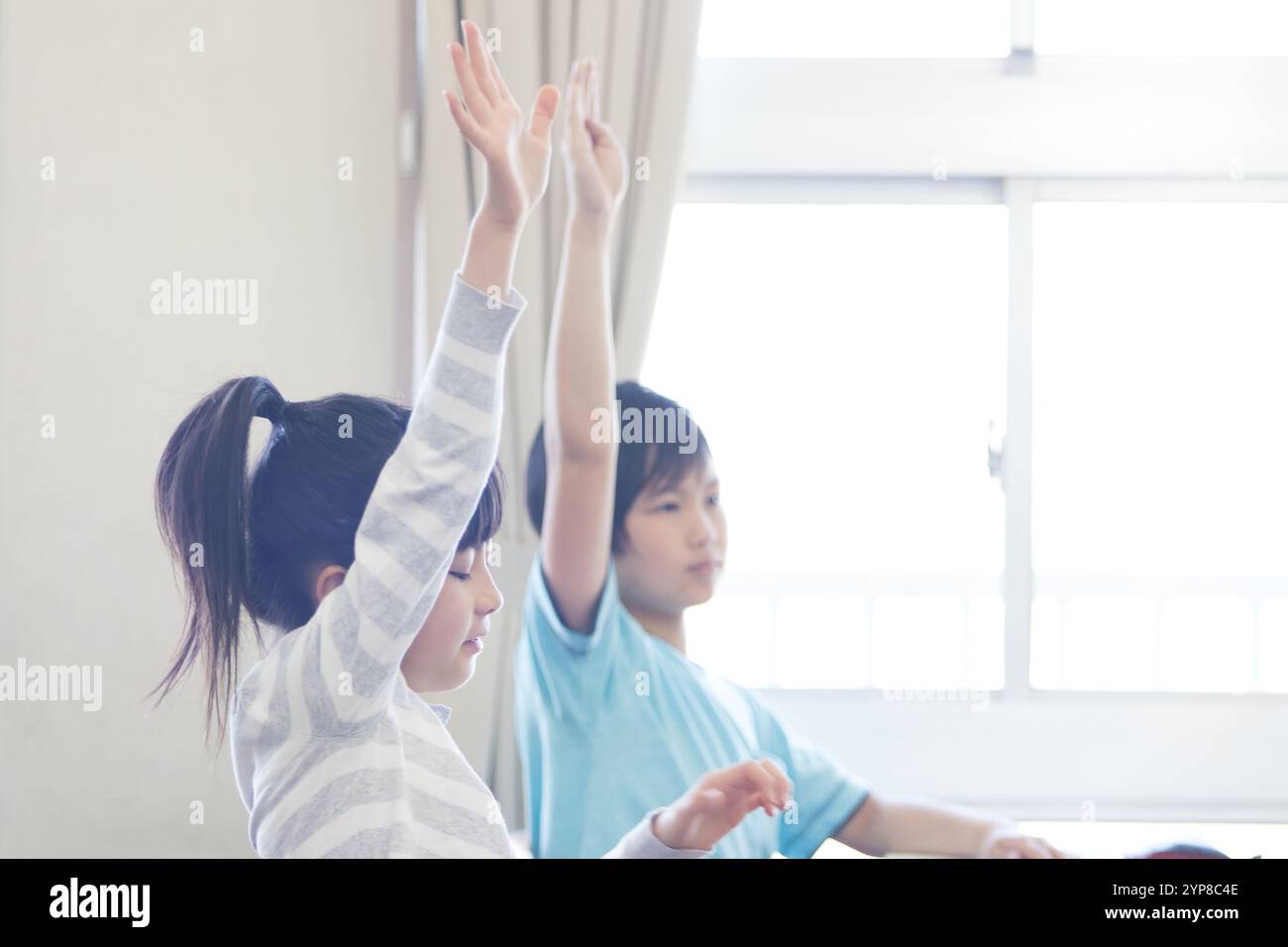 Primary schools students studying in a classroom Stock Photo - Alamy