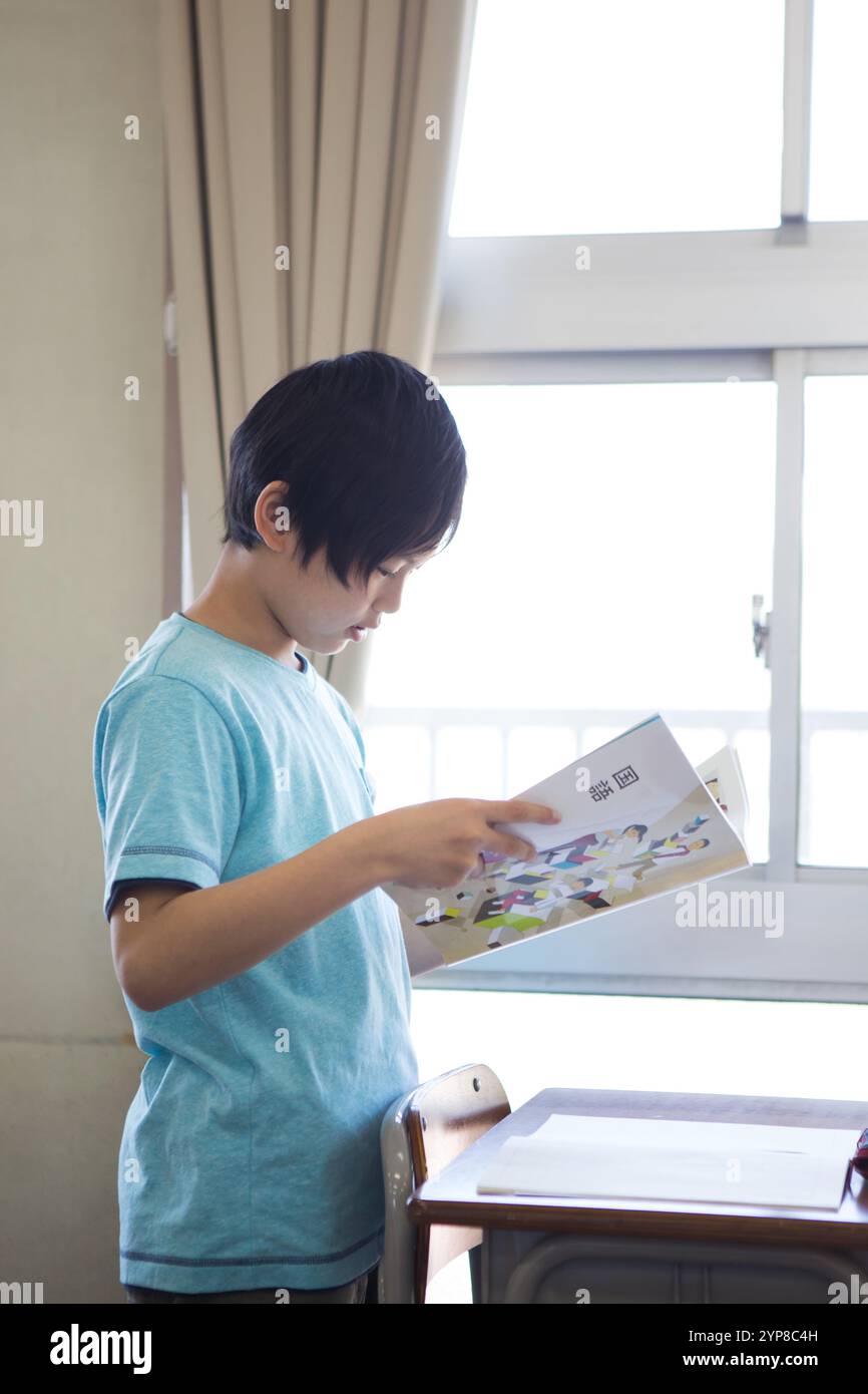 Primary schools students studying in a classroom Stock Photo - Alamy