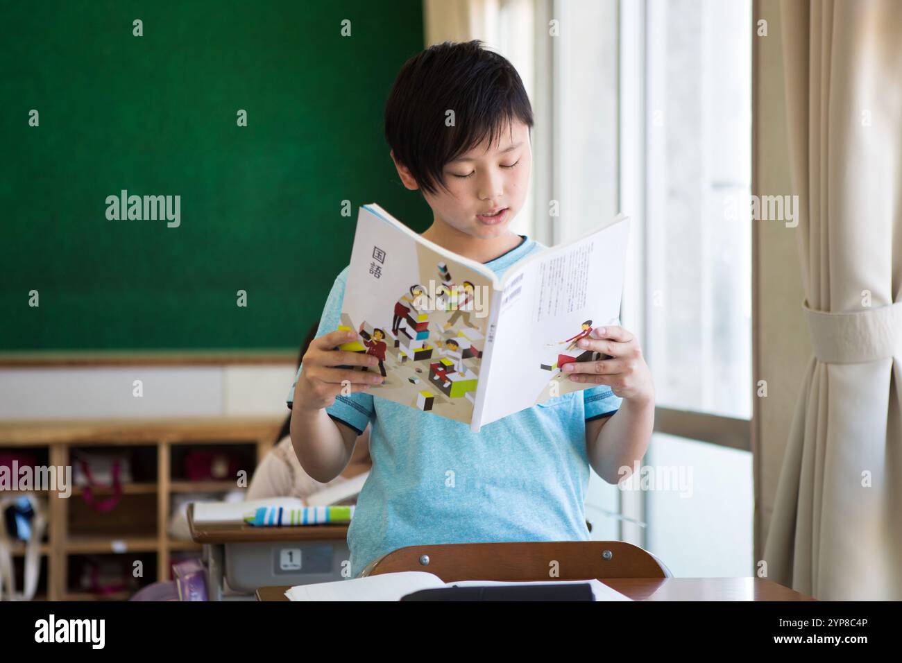 Primary schools students studying in a classroom Stock Photo - Alamy