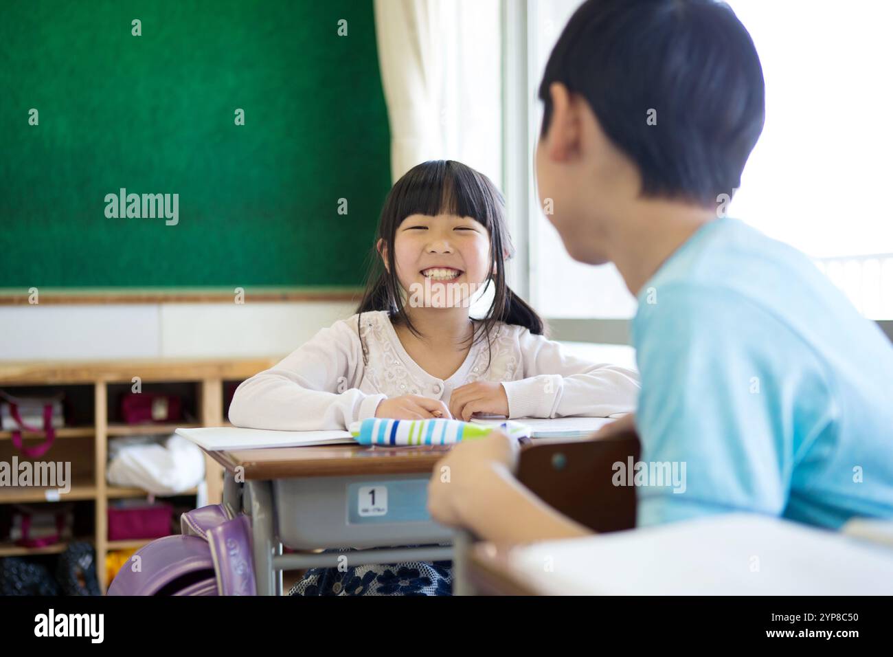 Primary schools students studying in a classroom Stock Photo - Alamy