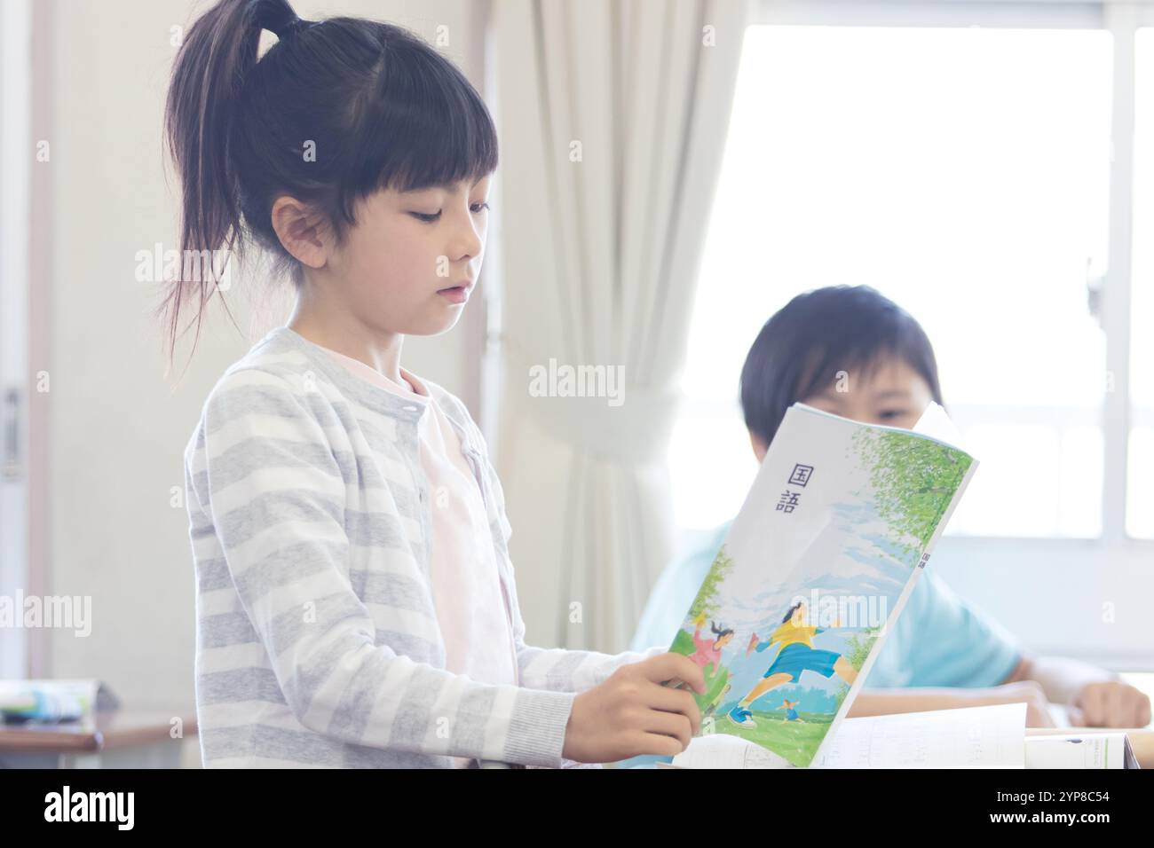 Primary schools students studying in a classroom Stock Photo - Alamy