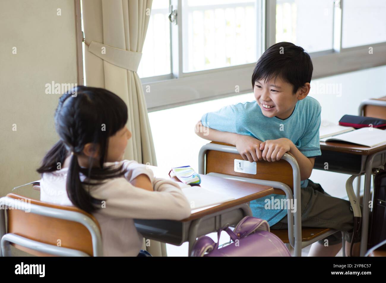 Primary schools students studying in a classroom Stock Photo - Alamy