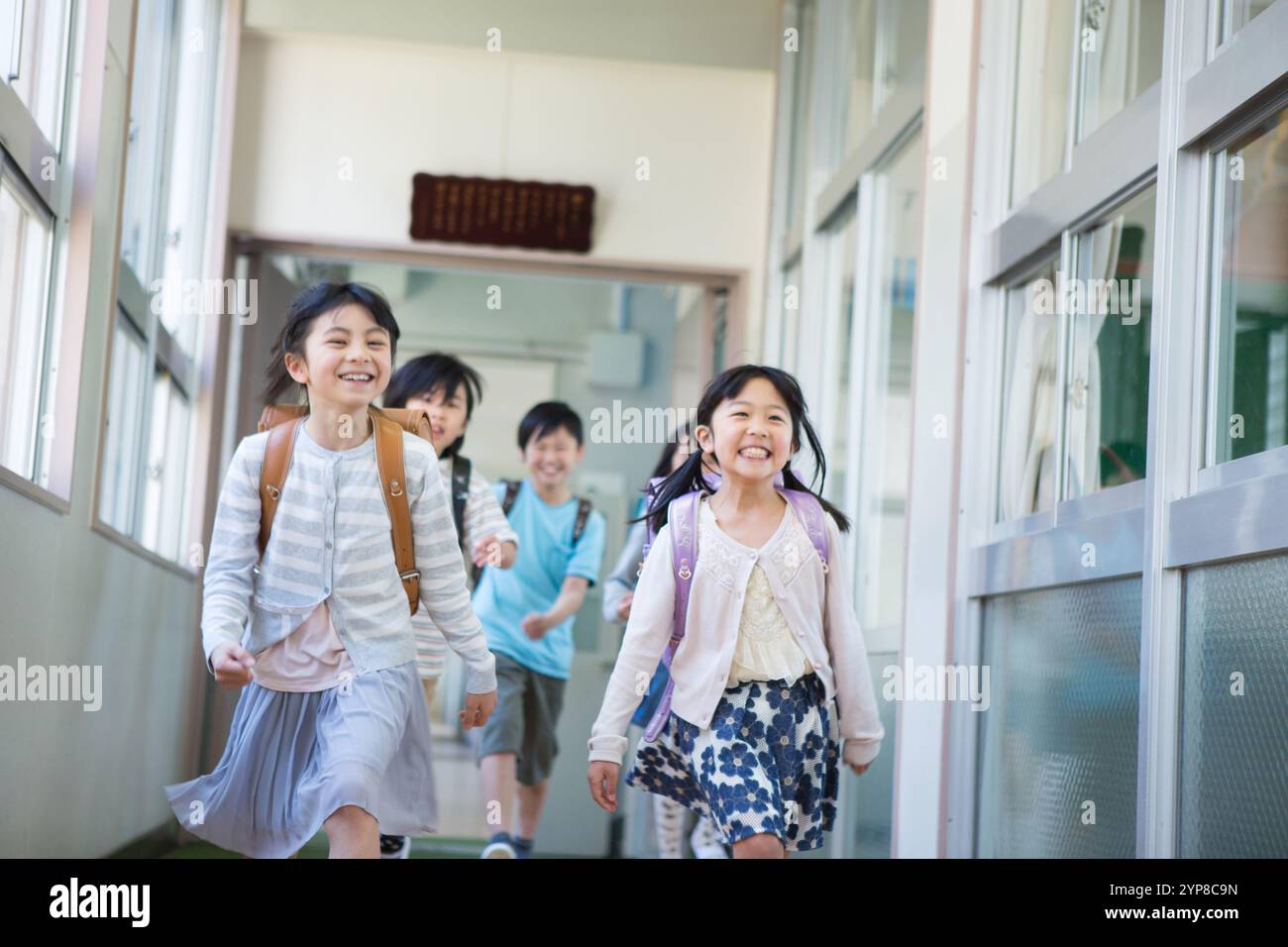 Primary school children carrying school backpacks Stock Photo - Alamy