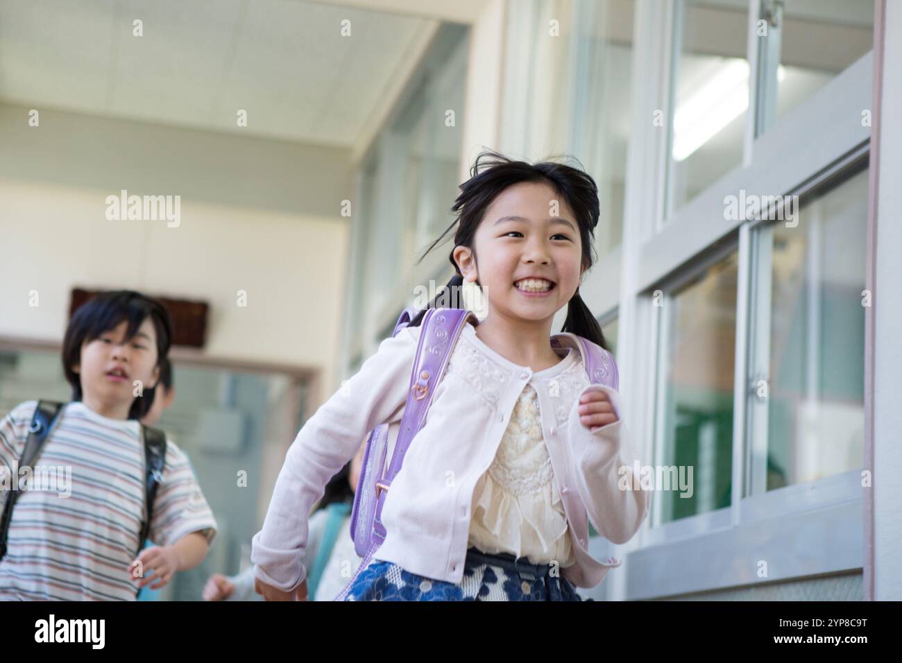 Primary school children carrying school backpacks Stock Photo - Alamy
