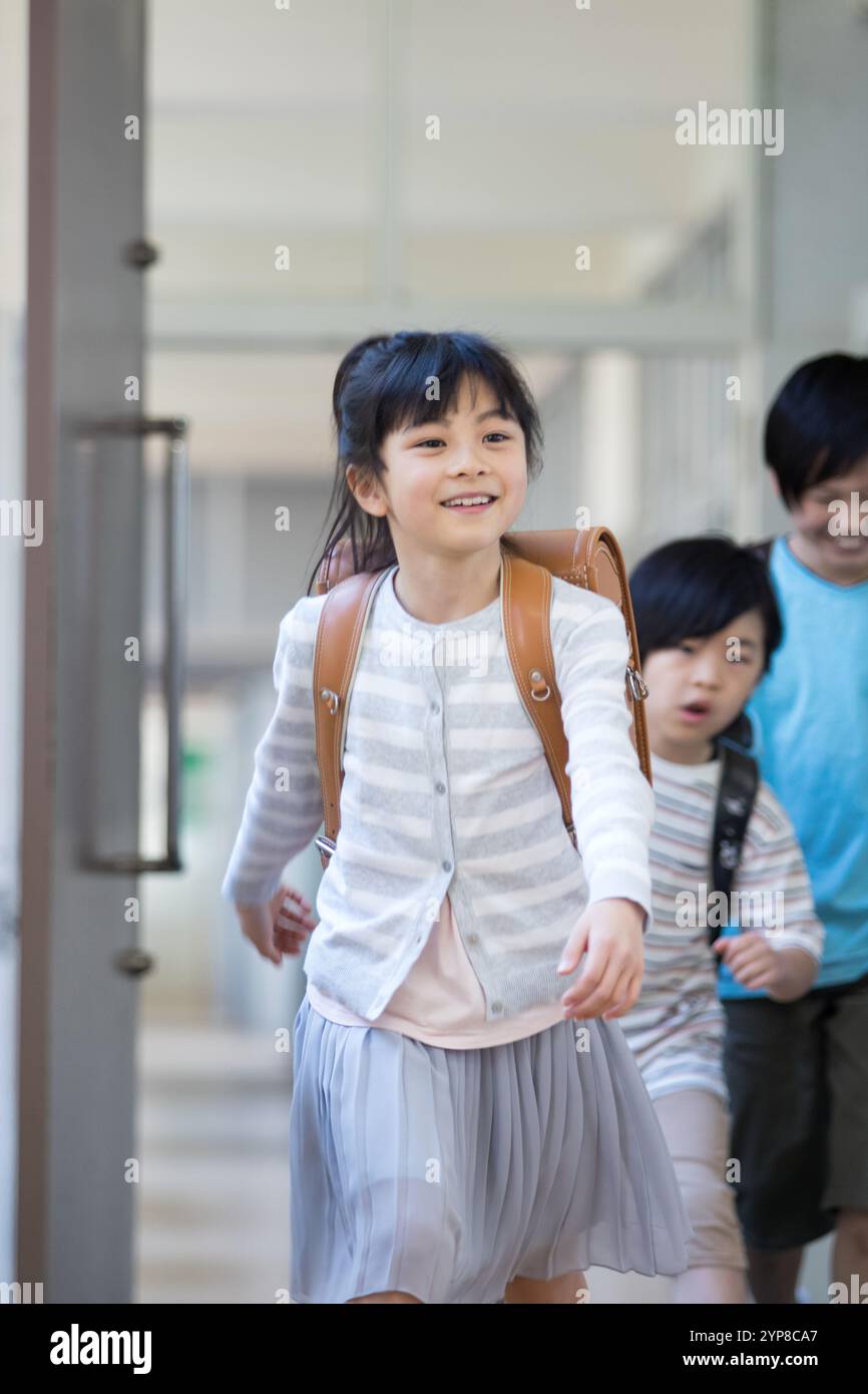 Primary school children carrying school backpacks Stock Photo - Alamy