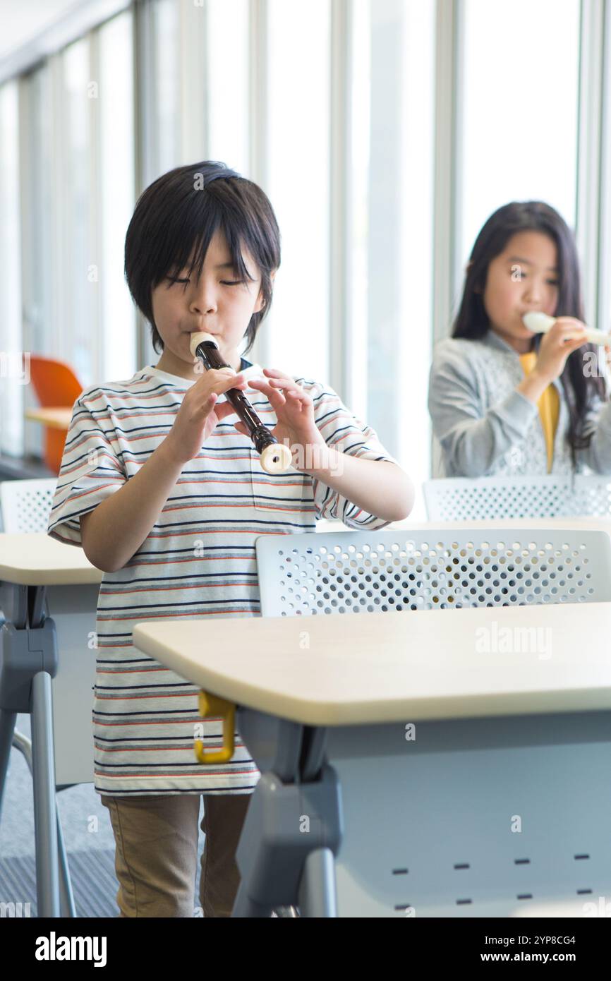 Primary school children taking music lessons Stock Photo - Alamy
