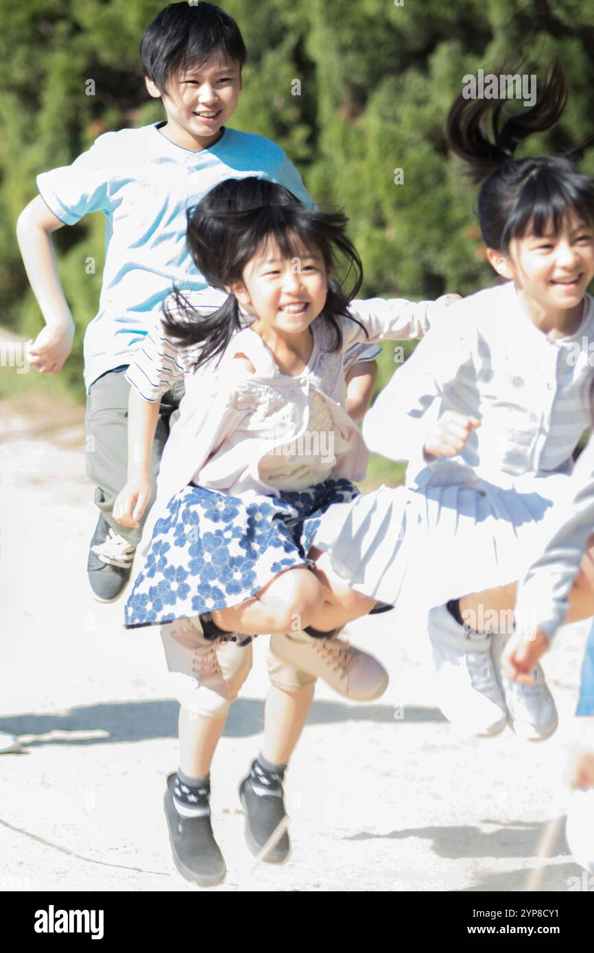 Primary school children jumping rope Stock Photo - Alamy