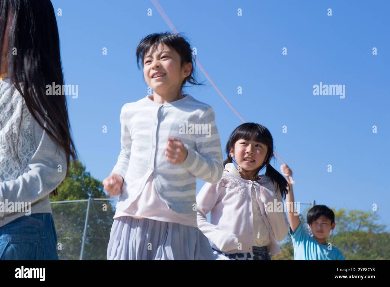 Primary school children jumping rope Stock Photo - Alamy