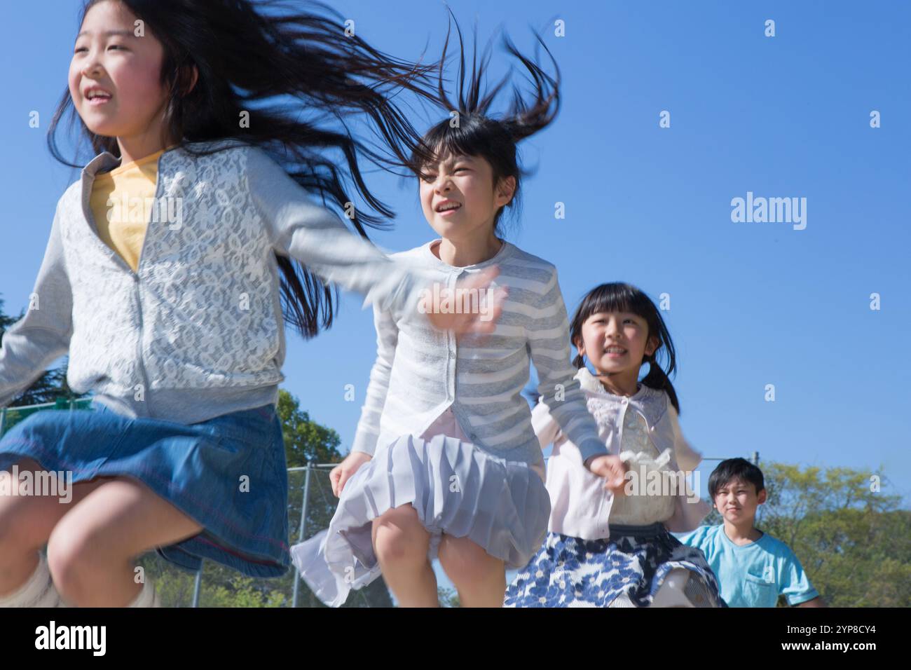 Primary school children jumping rope Stock Photo - Alamy