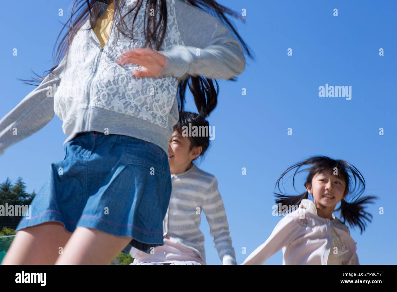 Primary school children jumping rope Stock Photo - Alamy