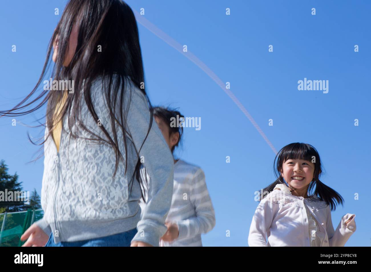 Primary school children jumping rope Stock Photo - Alamy