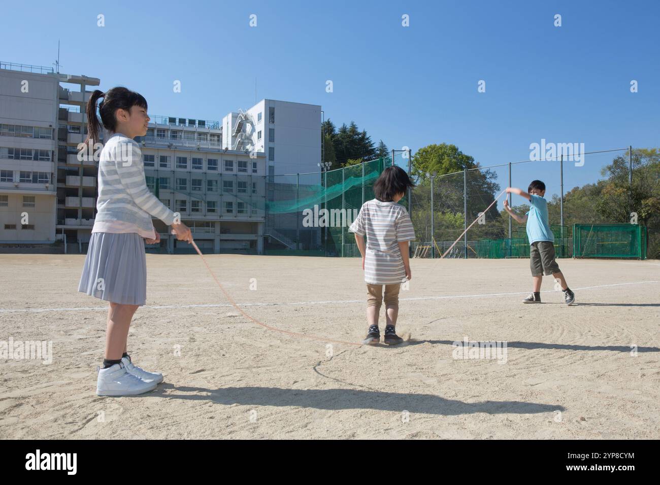 Primary school children jumping rope Stock Photo - Alamy