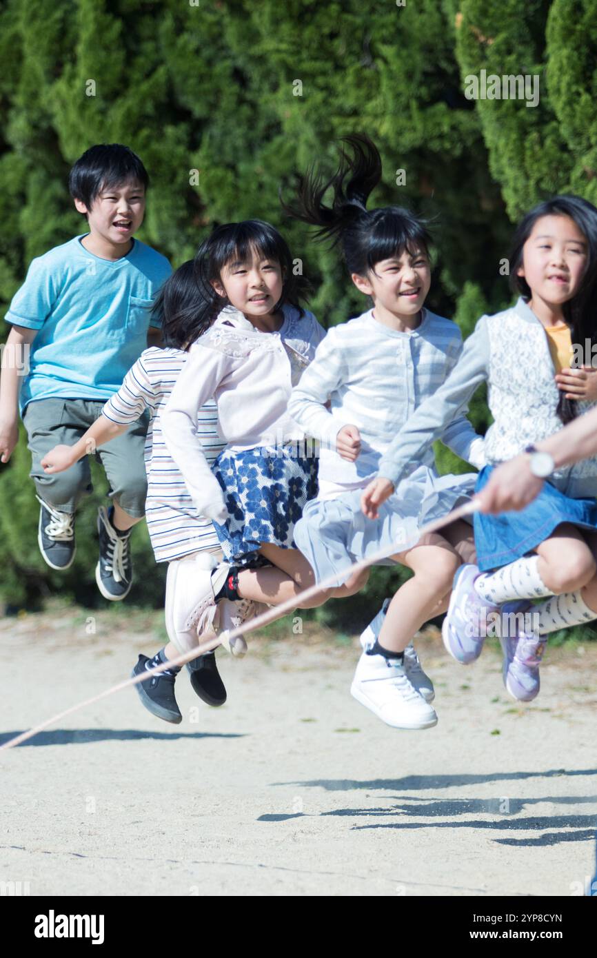Primary school children jumping rope Stock Photo - Alamy