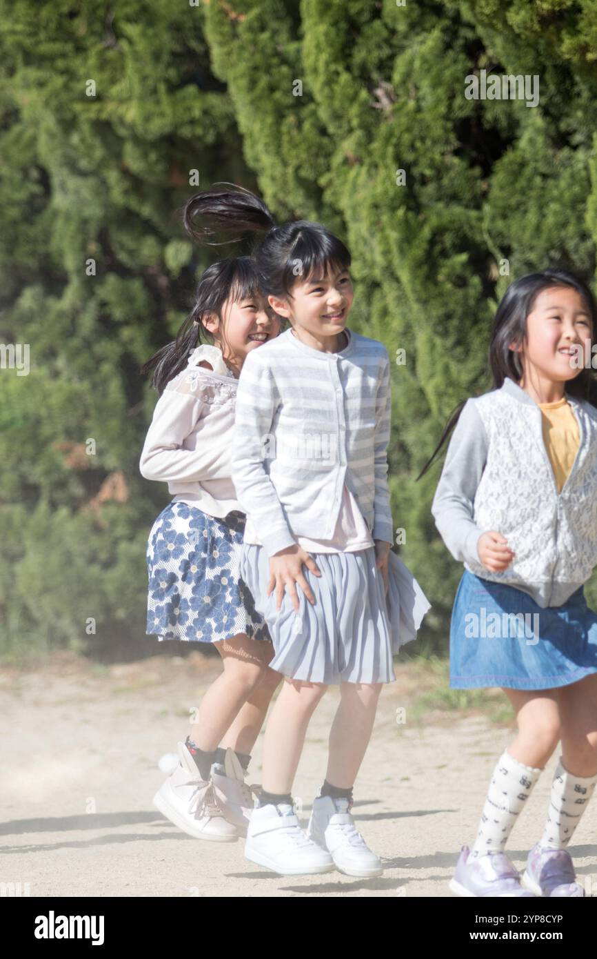 Primary school children jumping rope Stock Photo - Alamy