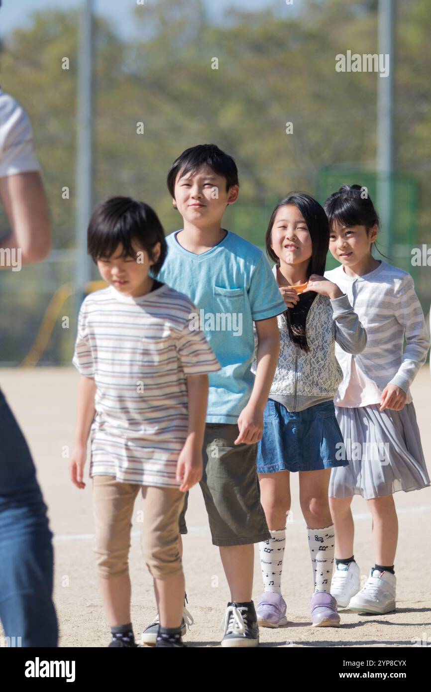 Primary school children jumping rope Stock Photo - Alamy
