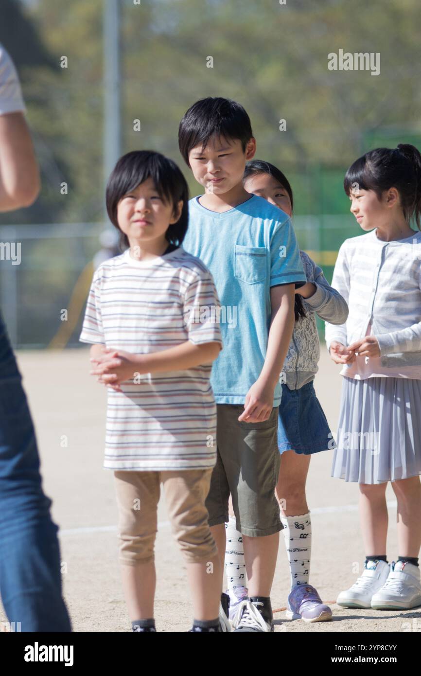 Primary school children jumping rope Stock Photo - Alamy