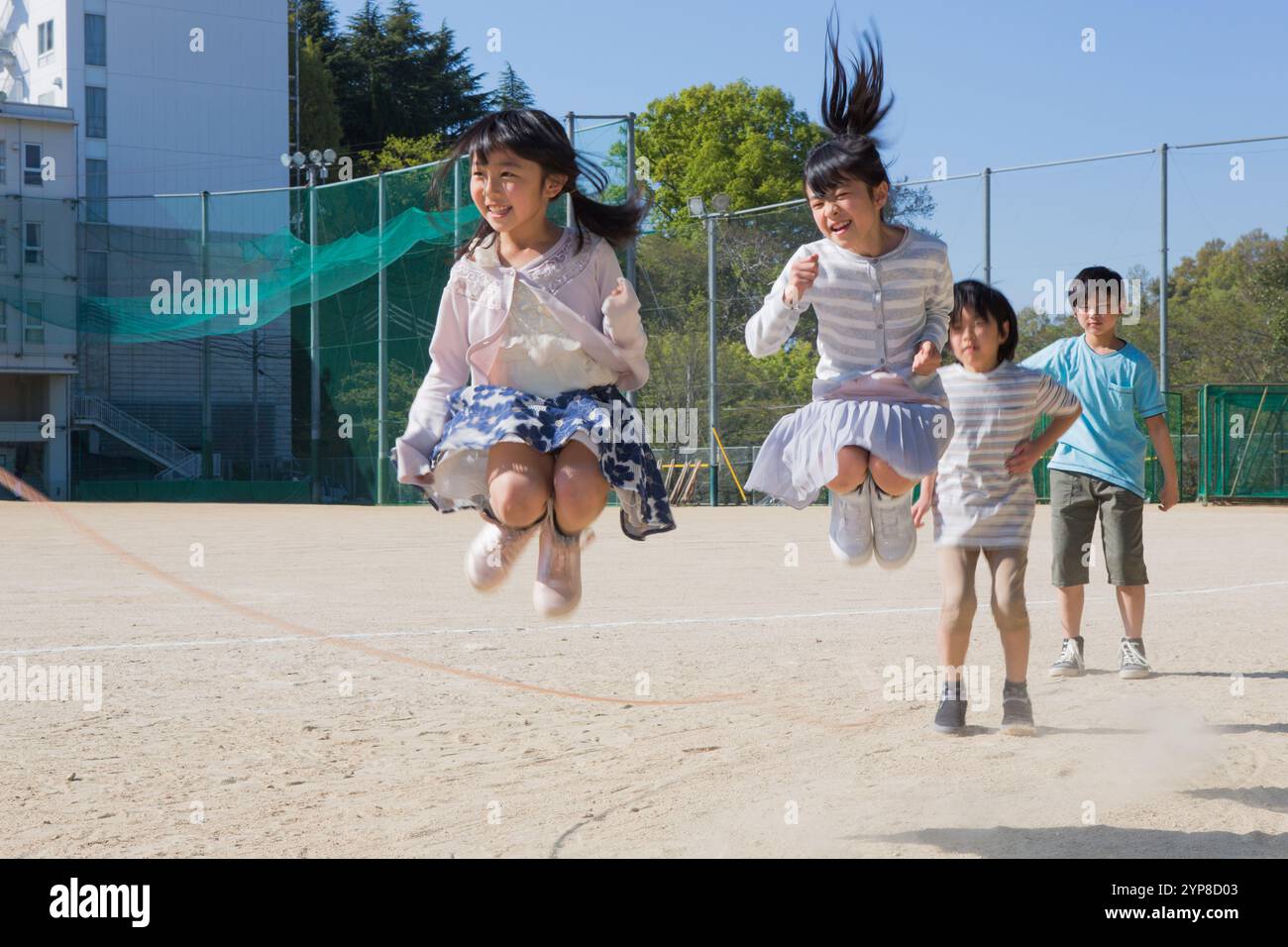 Primary school children jumping rope Stock Photo - Alamy