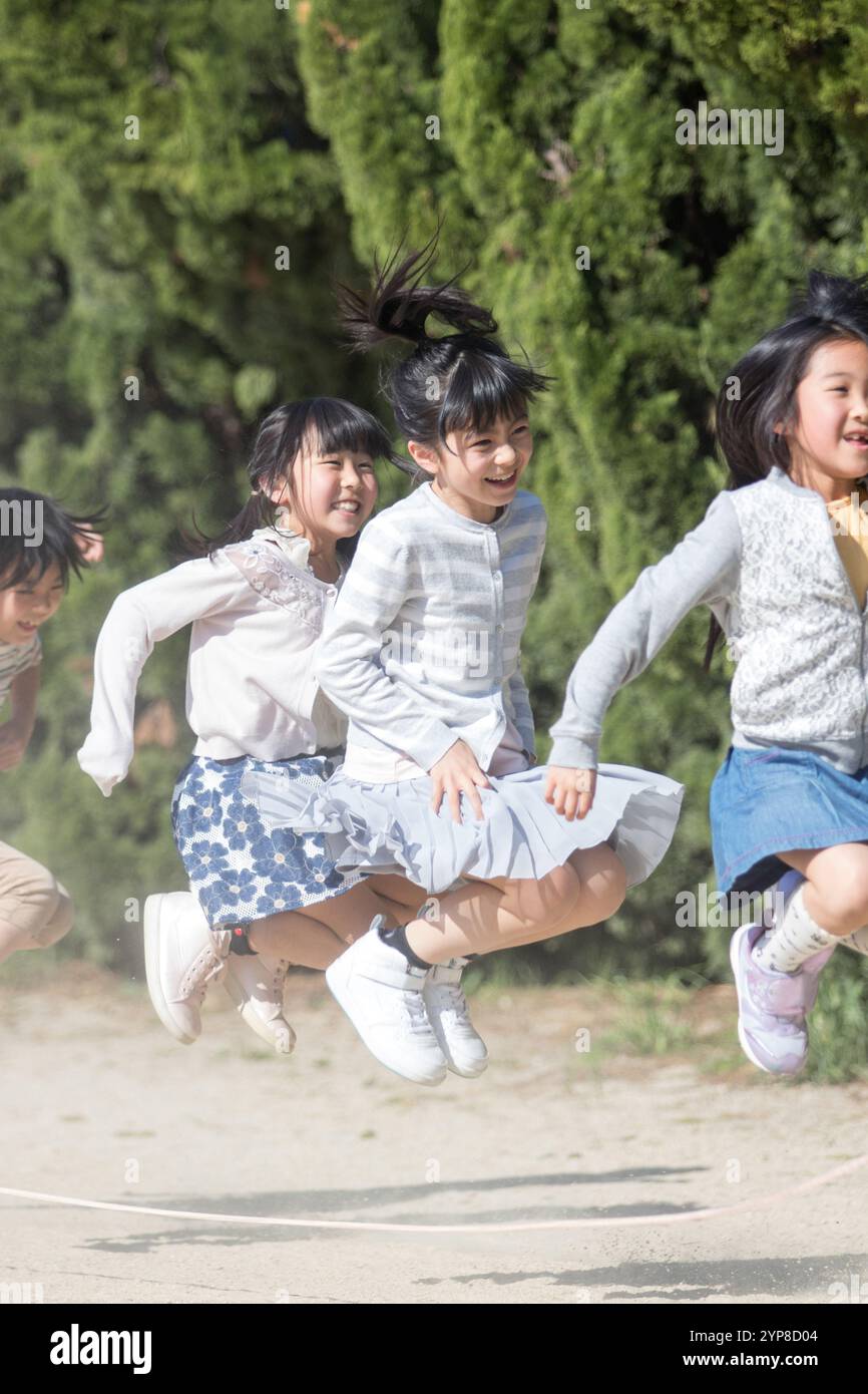 Primary school children jumping rope Stock Photo - Alamy