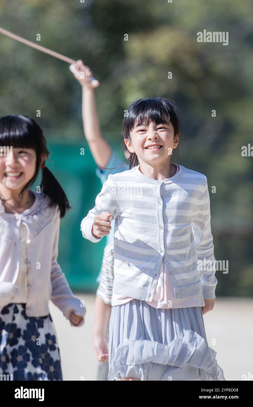 Primary school children jumping rope Stock Photo - Alamy