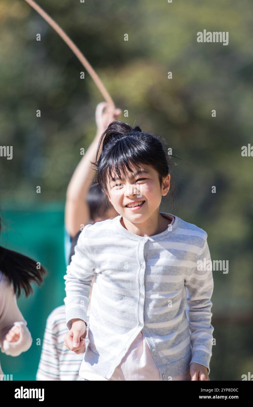 Primary school children jumping rope Stock Photo - Alamy
