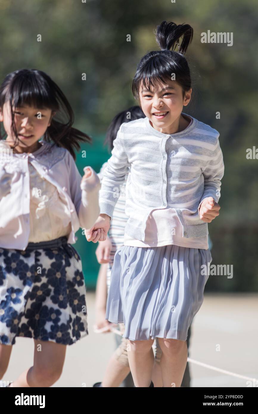 Primary school children jumping rope Stock Photo - Alamy