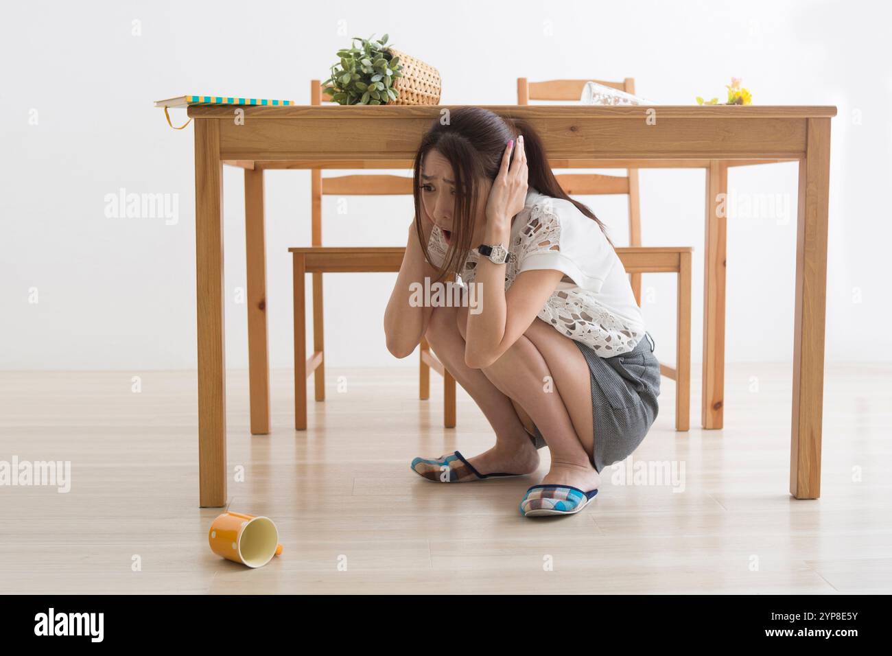 Woman hide under table hi-res stock photography and images - Alamy