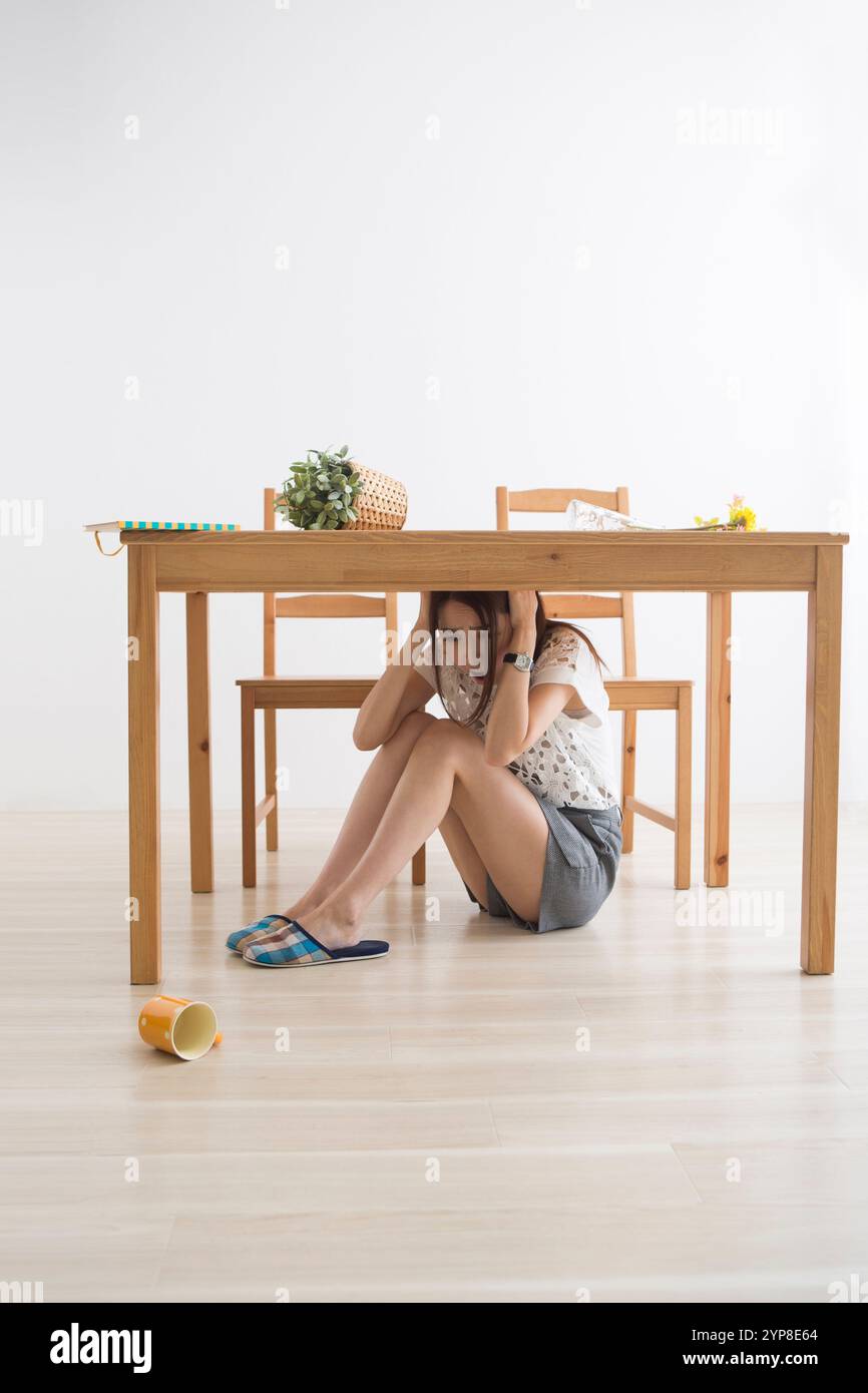 Woman hide under table hi-res stock photography and images - Alamy