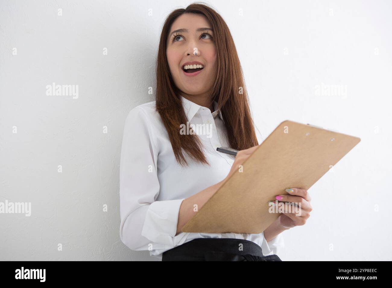 Woman taking notes Stock Photo - Alamy
