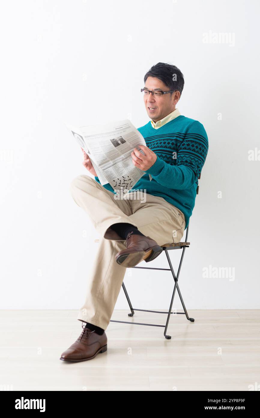 Middle men reading newspapers Stock Photo - Alamy